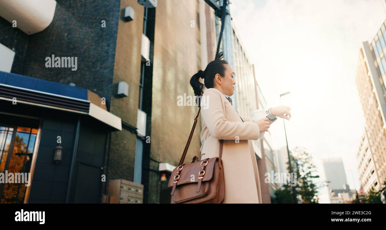 Businesswoman, japan and walking to work in city by office buildings ...