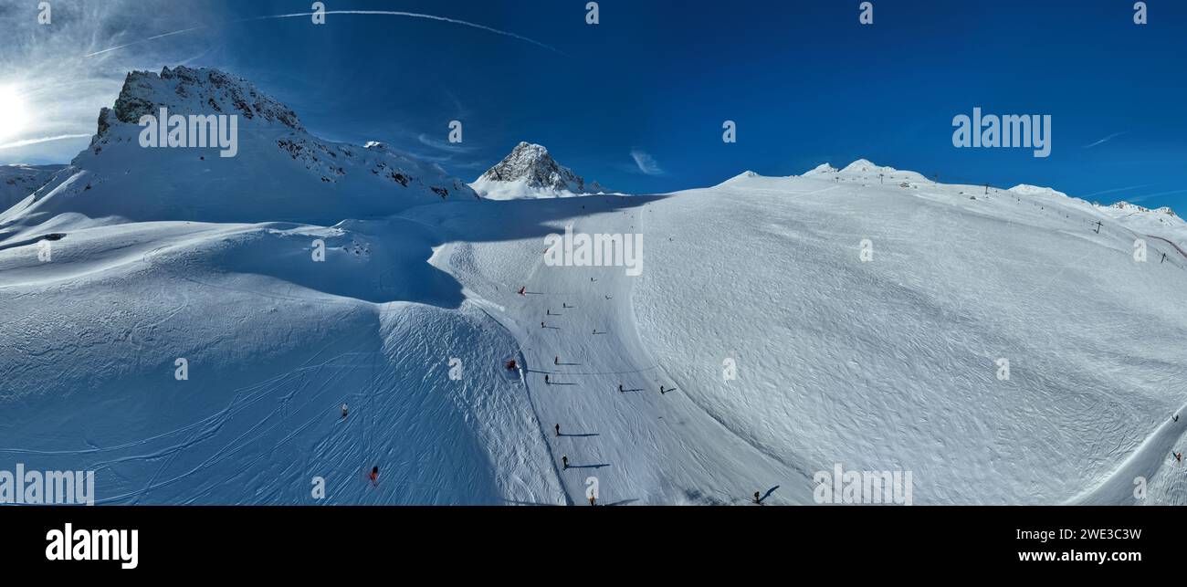 Winter drone shot of ski pistes and slopes covered with fresh powder ...