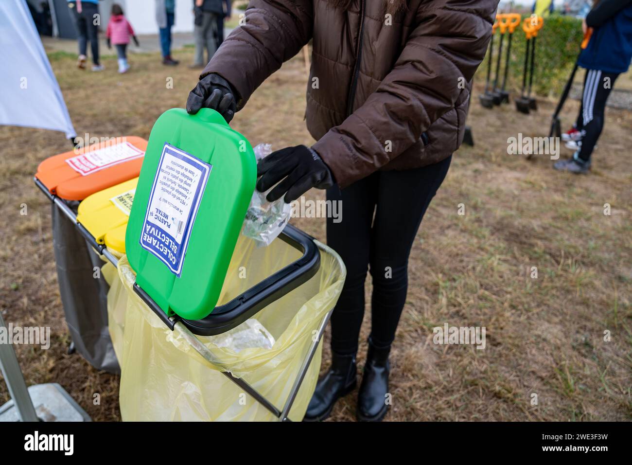 A group of people throwing garbage in the recycling garbage trash Stock ...