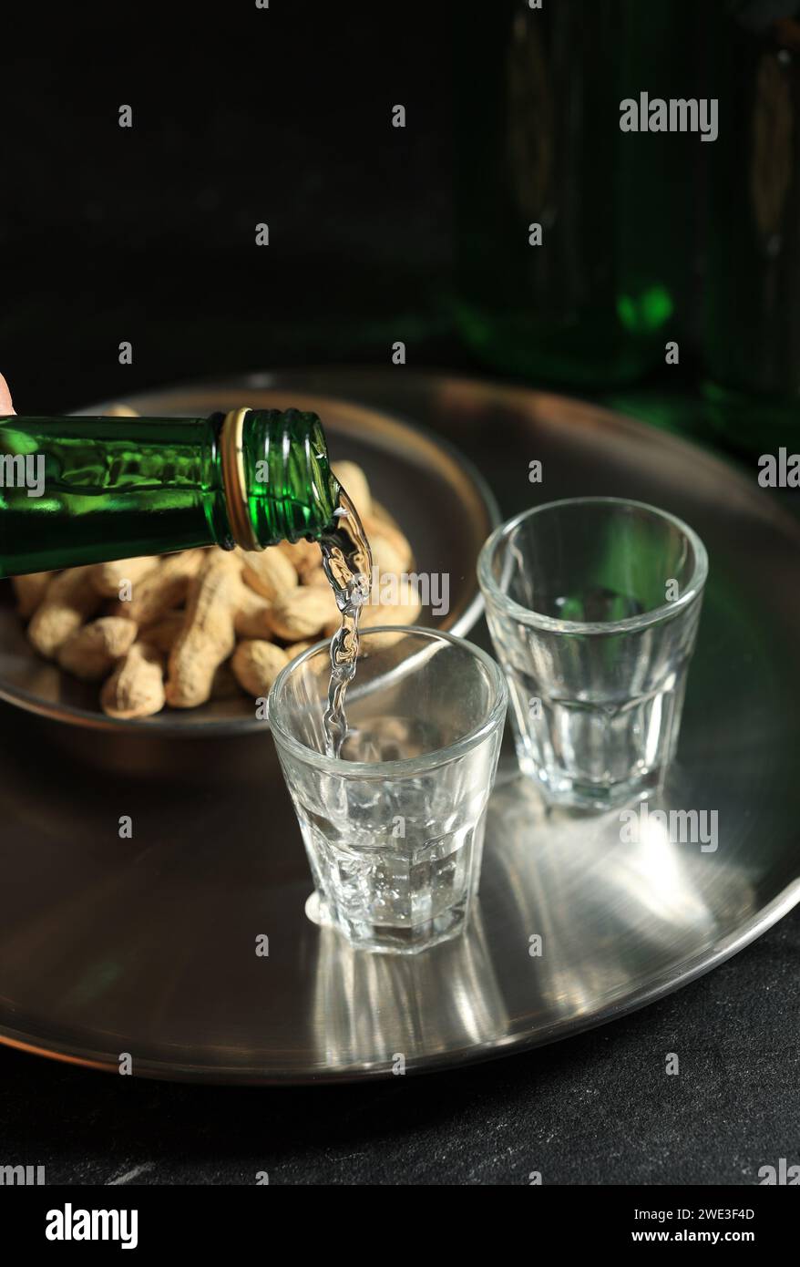 Pouring Soju or Mineral Water to Small Glass Cup. Alcoholic Clear ...