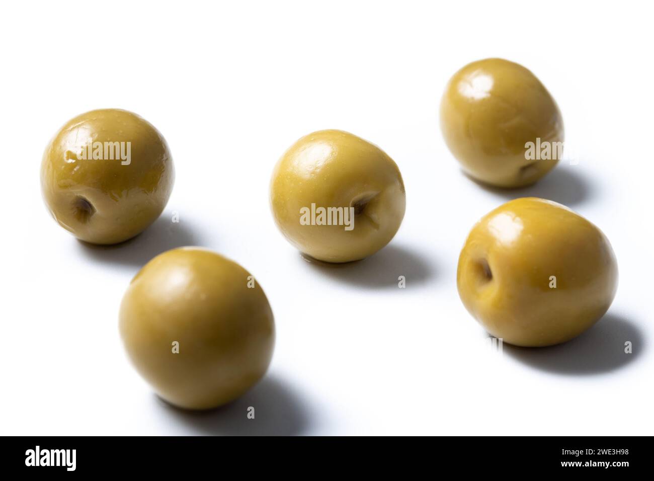Close-up of olives with olive leaves, isolated on white background ...