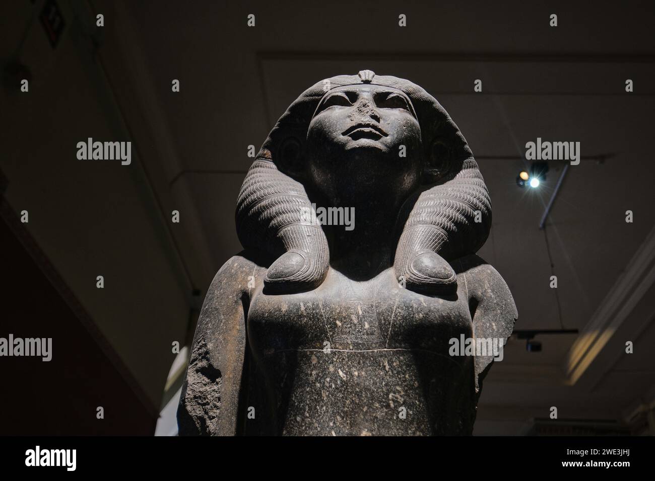 Cairo, Egypt - January 2, 2024: Black granite statue of Queen Nofret ... Cairo, Egypt - January 2, 2024: Black granite statue of Queen Nofret ...