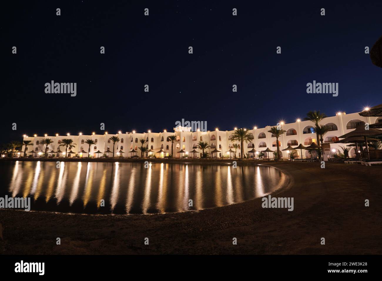 Hurghada, Egypt - January 03, 2024: Beach on Red Sea in front of a Bel ...