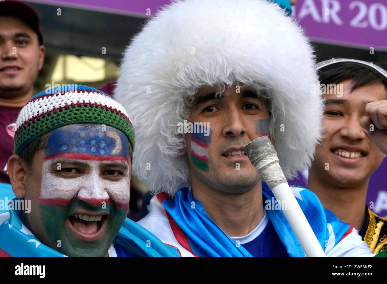 Uzbek fans cheer for their team during the Asian Cup Group B soccer ...