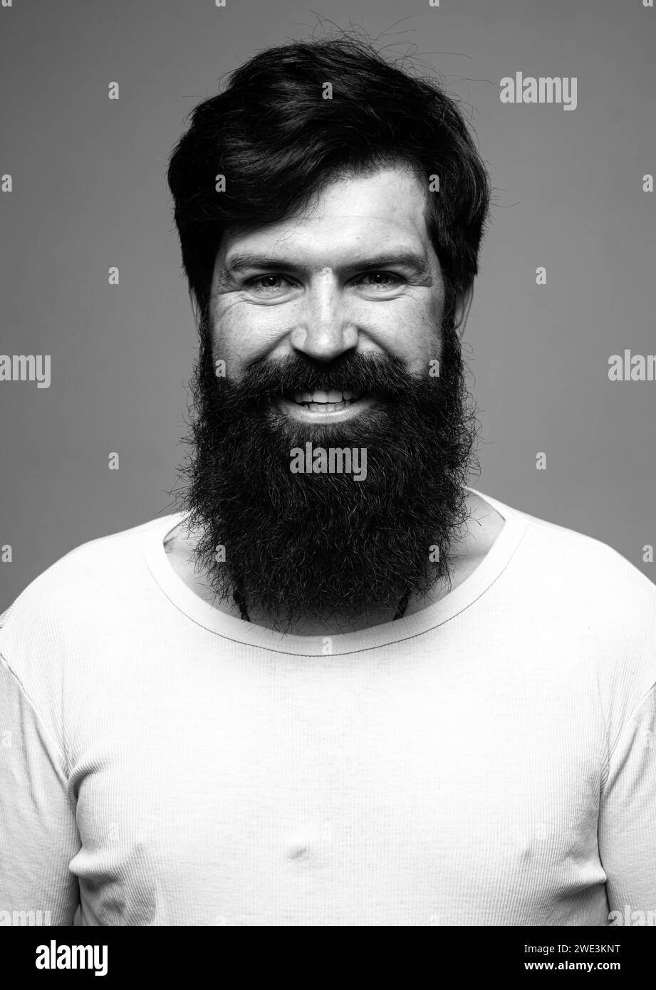 Happy man smile face. Handsome smiling young guy in studio on gray dark ...