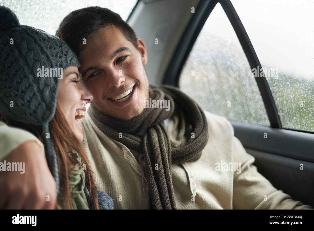 Love, raining and couple in car for road trip together, laughing on ...