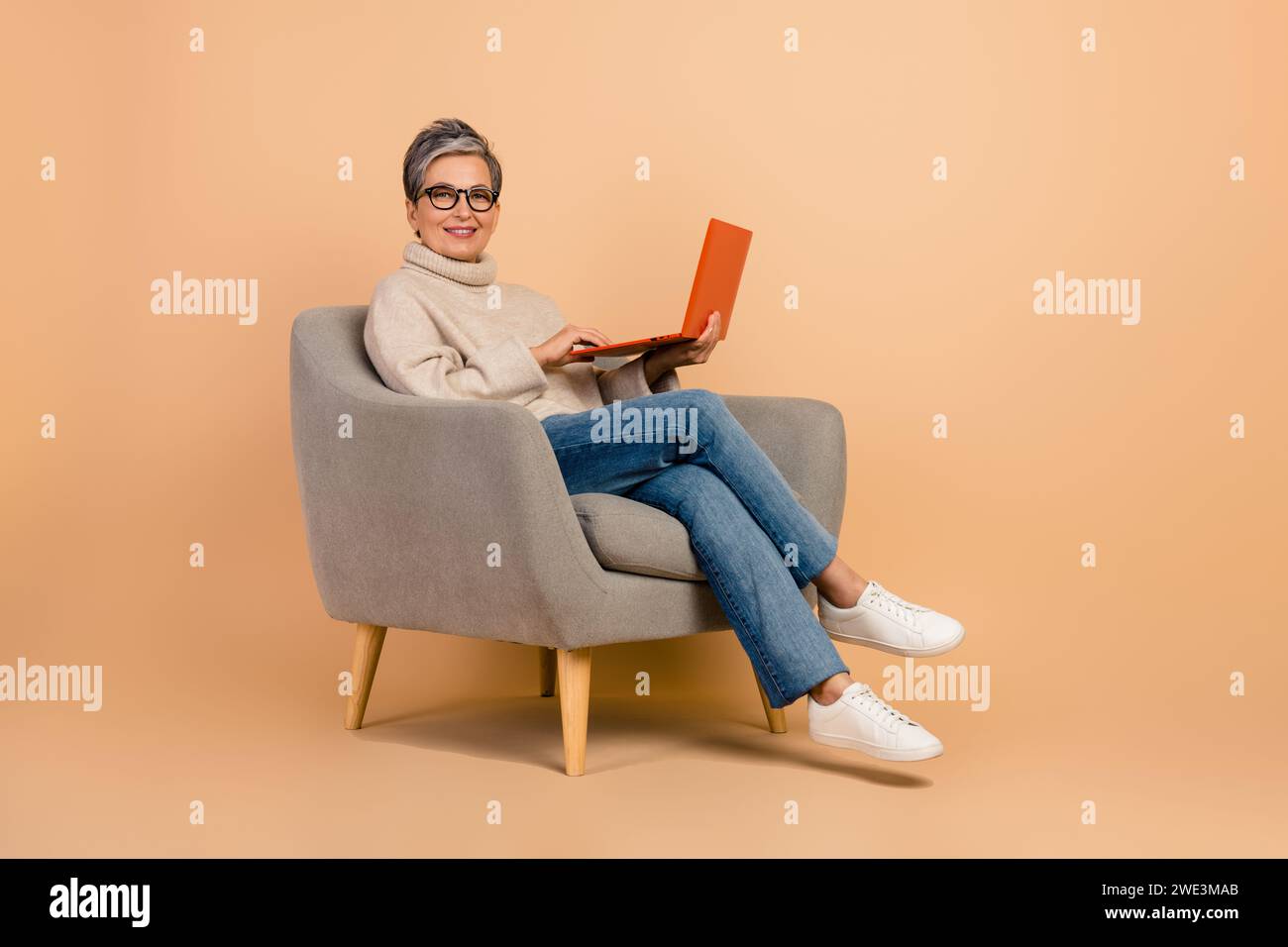 Full length photo of senior it specialist woman using netbook distance ...