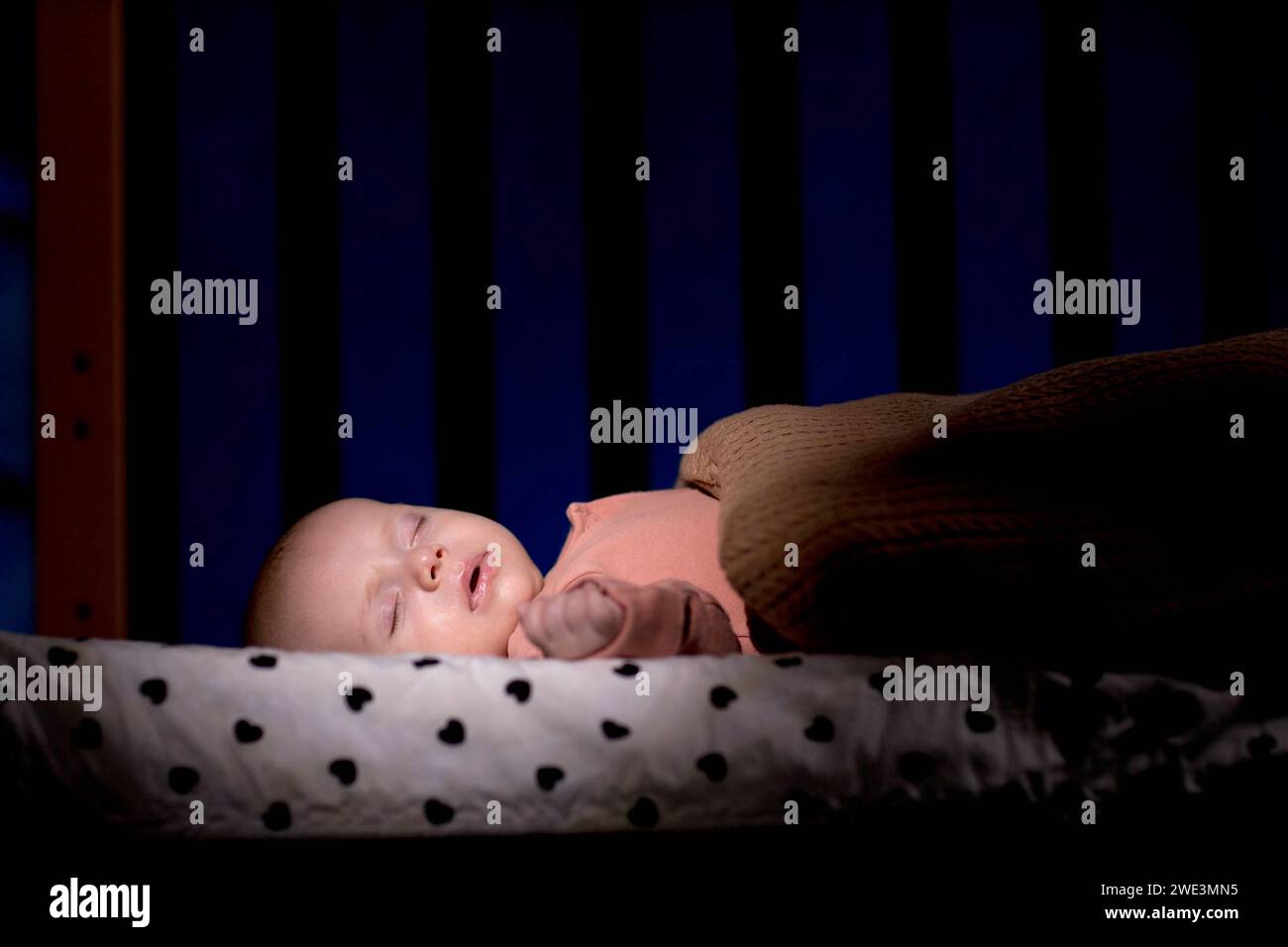 Cute little baby sleeping in cradle at home night Stock Photo - Alamy