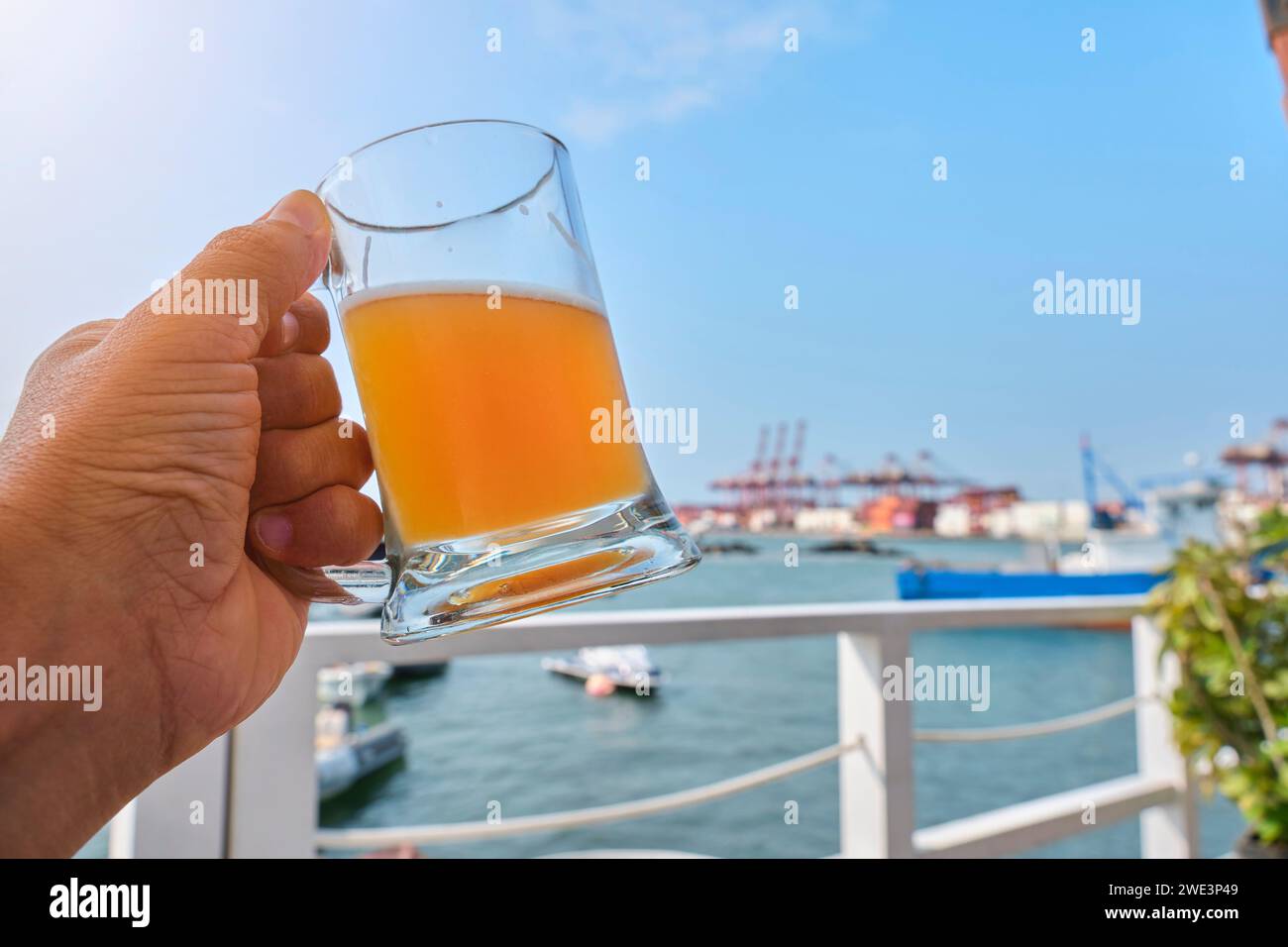 Male hand holding jar beer the beginning of summer at marina, summer ...