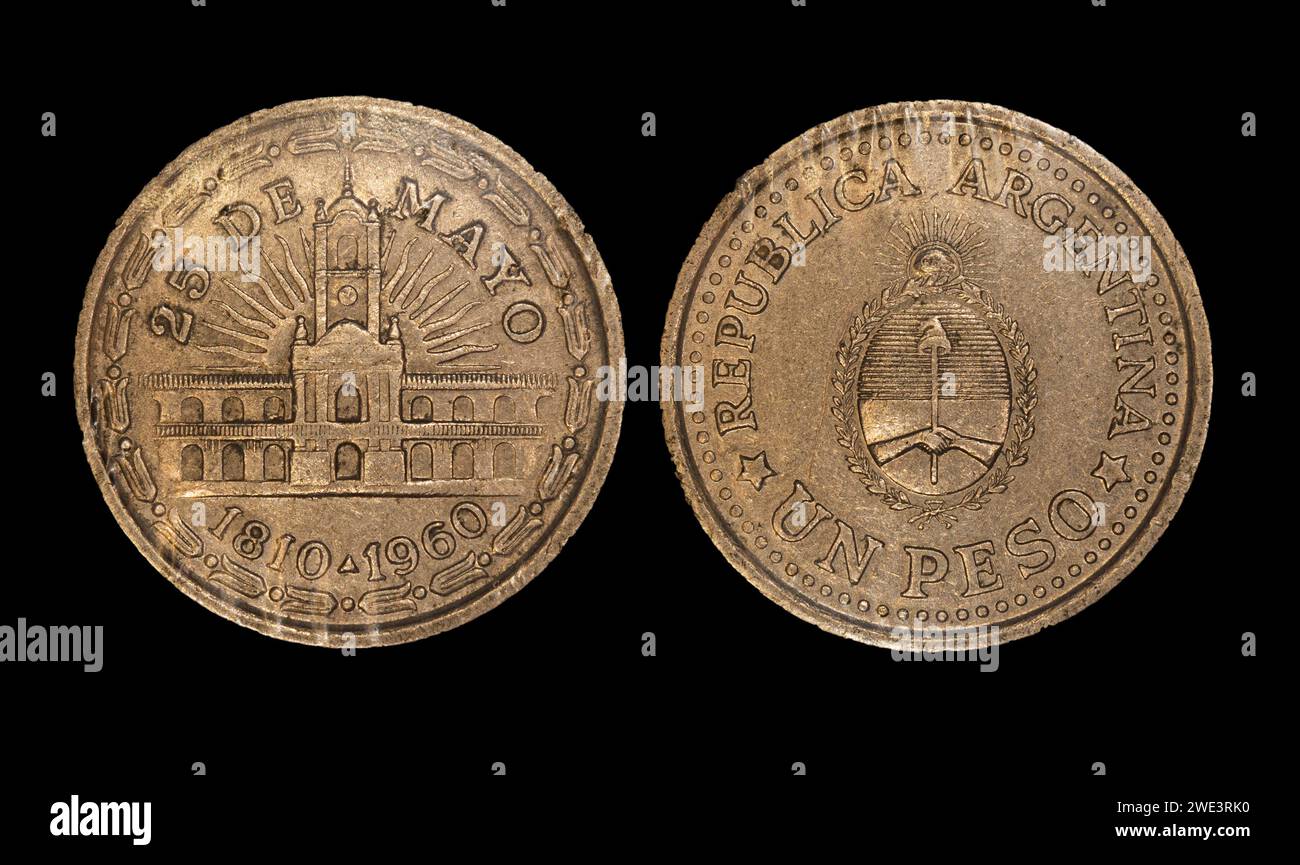 Two shiny gold coins resting on a sleek black surface: Argentina, one ...
