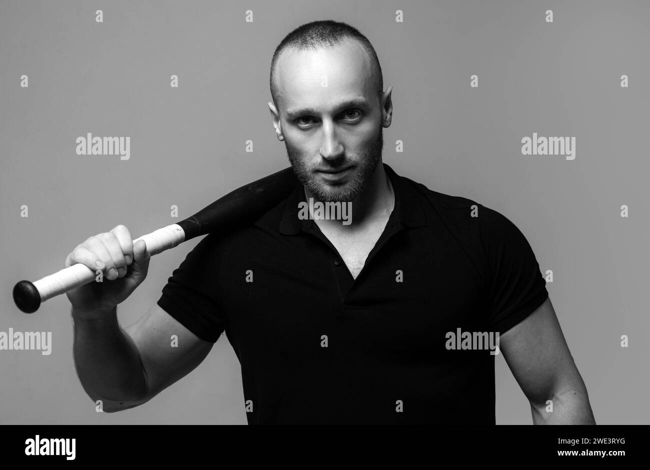 Portrait of handsome man with serious face. Guy with baseball bat for ...
