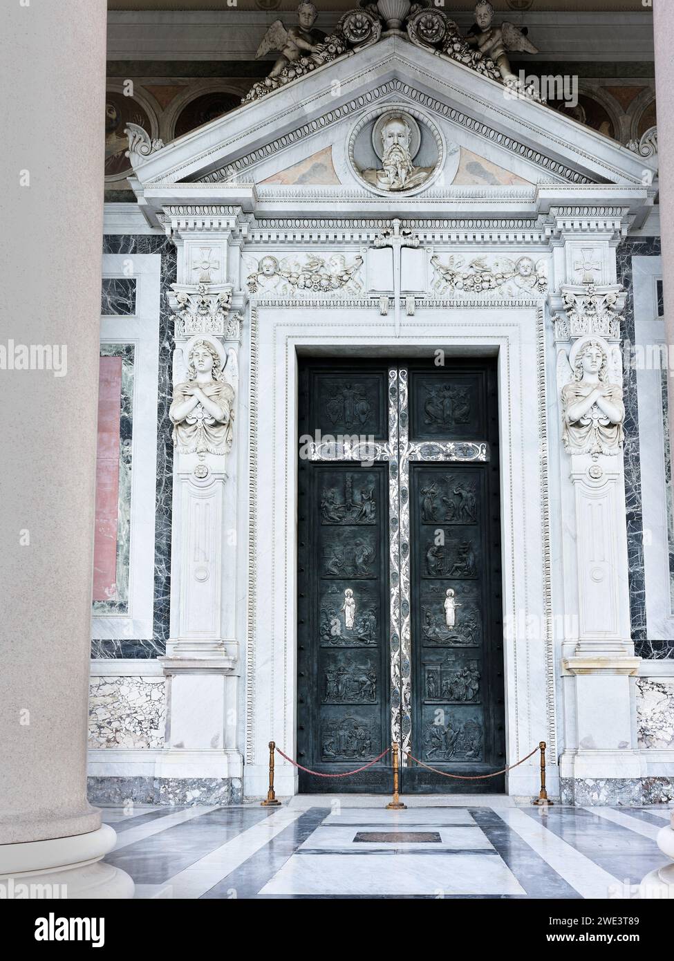 Cross on the west door to the papal basilica of St Paul outside the ...