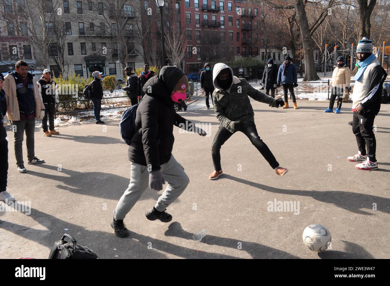 New York, United States. 22nd Jan, 2024. Migrants play soccer as they ...