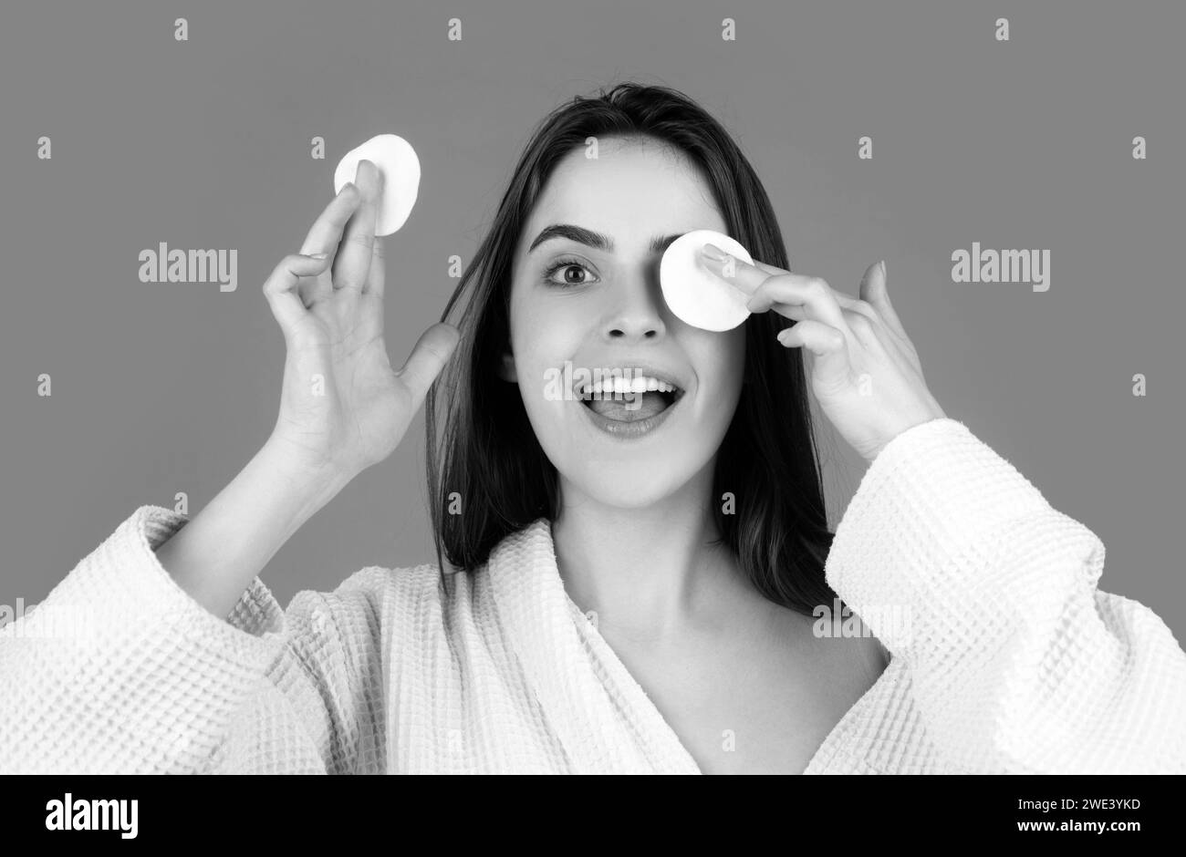 Beautiful young woman with clean fresh skin. Woman taking off makeup ...