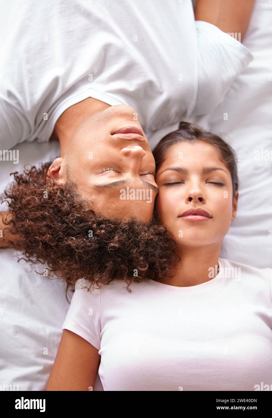 Sleeping, duvet and face of couple in bedroom for comfort, cozy nap and ...