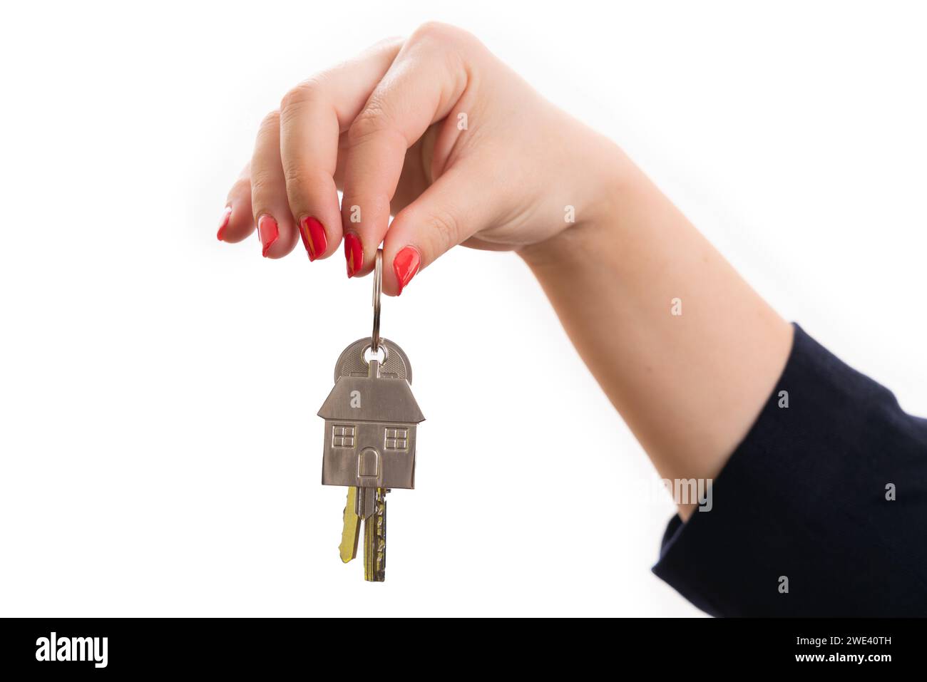 Close-up of female real-estate agent wearing suit presenting house keys ...