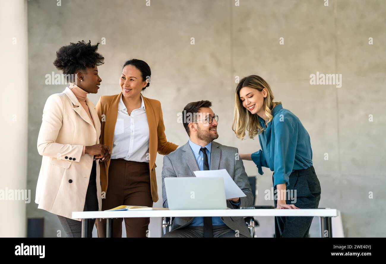 Happy businesspeople laughing while collaborating on a new project in an office Stock Photo - Alamy