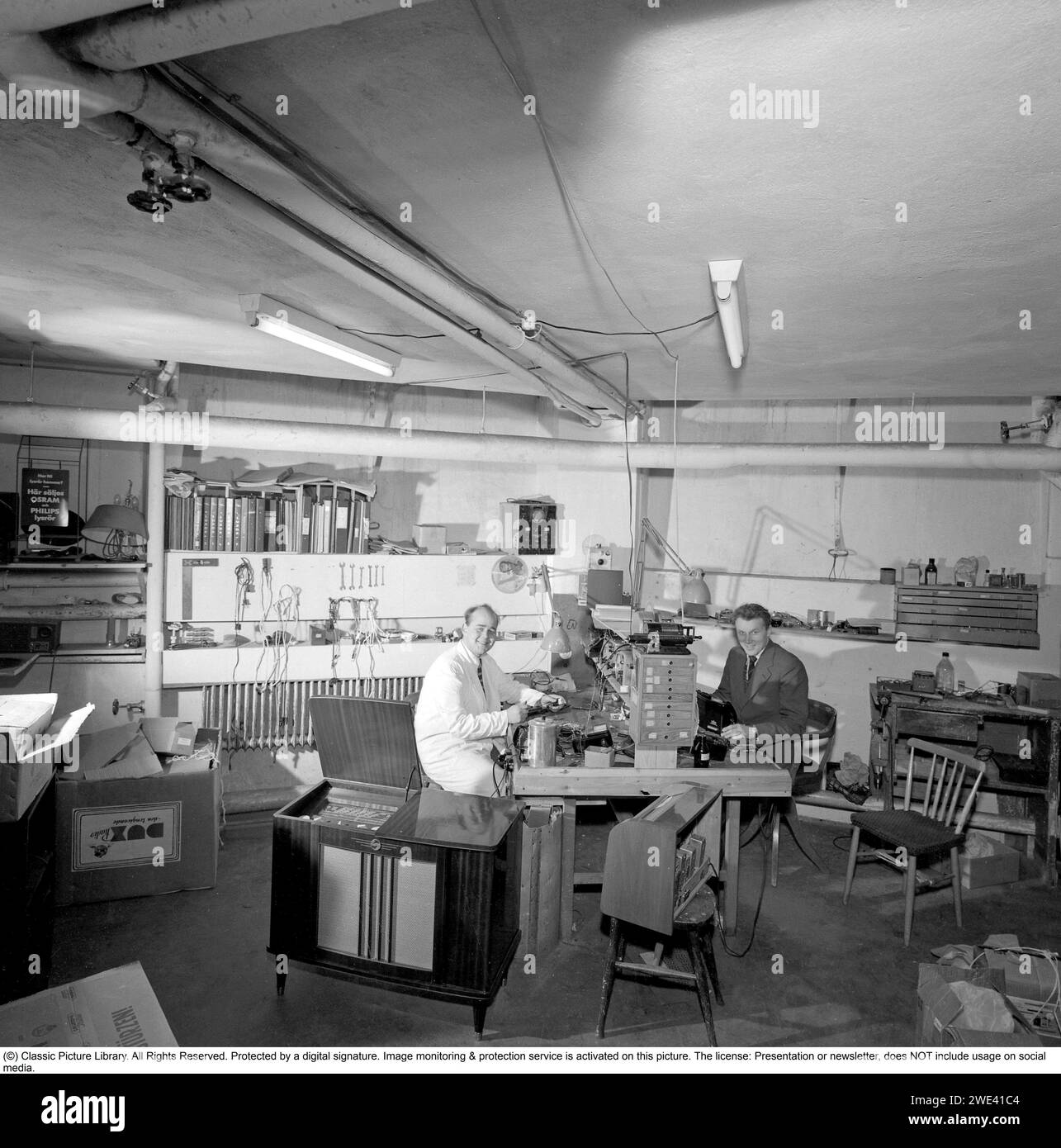 In the 1950s. Interior of a radio and tv service shop where radios and ...
