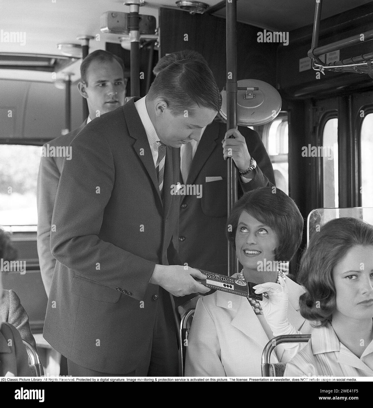 Mazetti chocolate. A young man on a bus offers a woman a piece from the ...