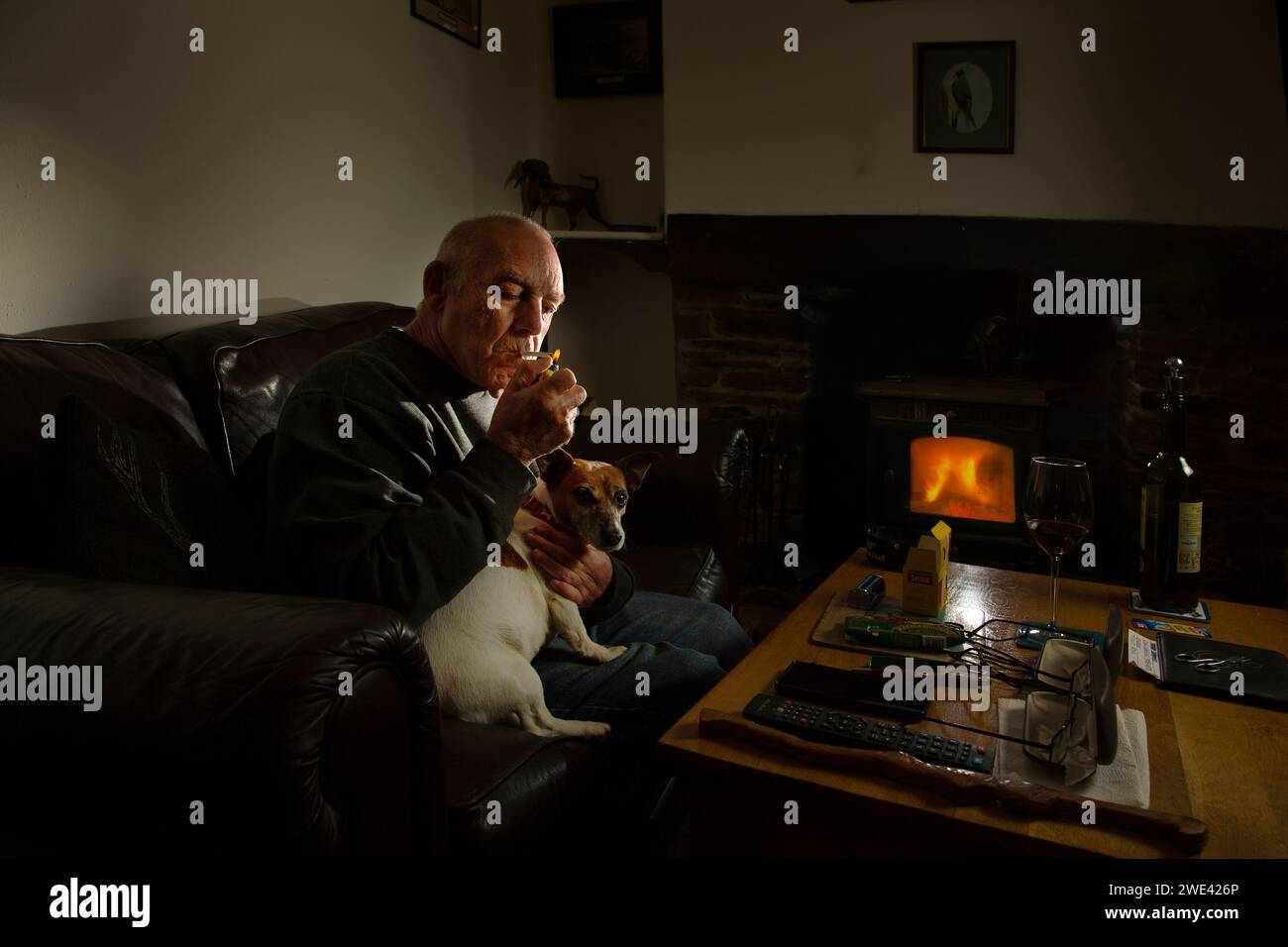old man lighting a cigarette Stock Photo - Alamy