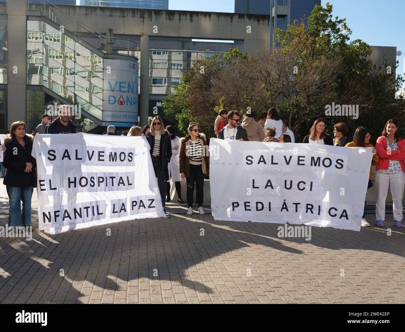 Demonstrators hold placards during a protest after the closure of the ...