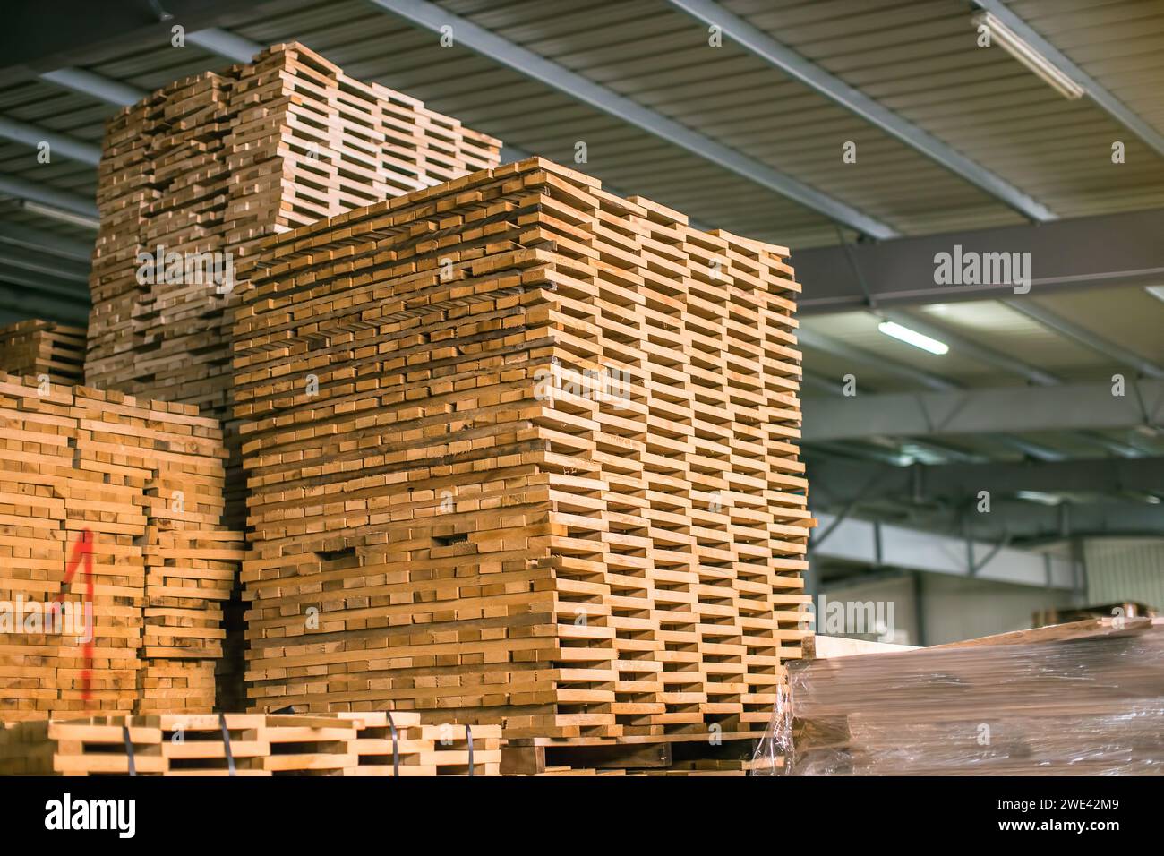 many wooden crates stacked on top of each other in factory warehouse ...