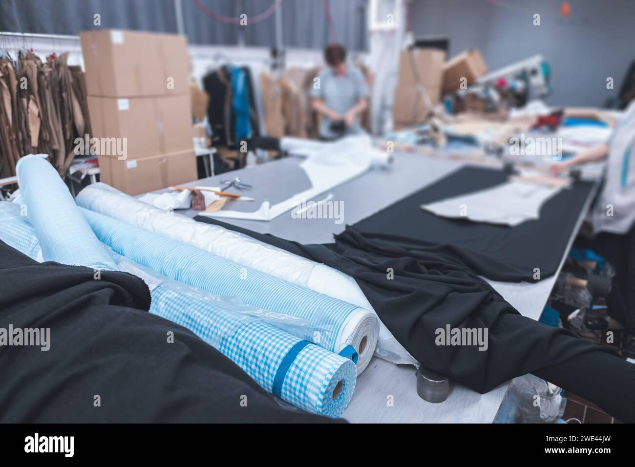 clothing manufacturing facility with fabric on table Stock Photo - Alamy