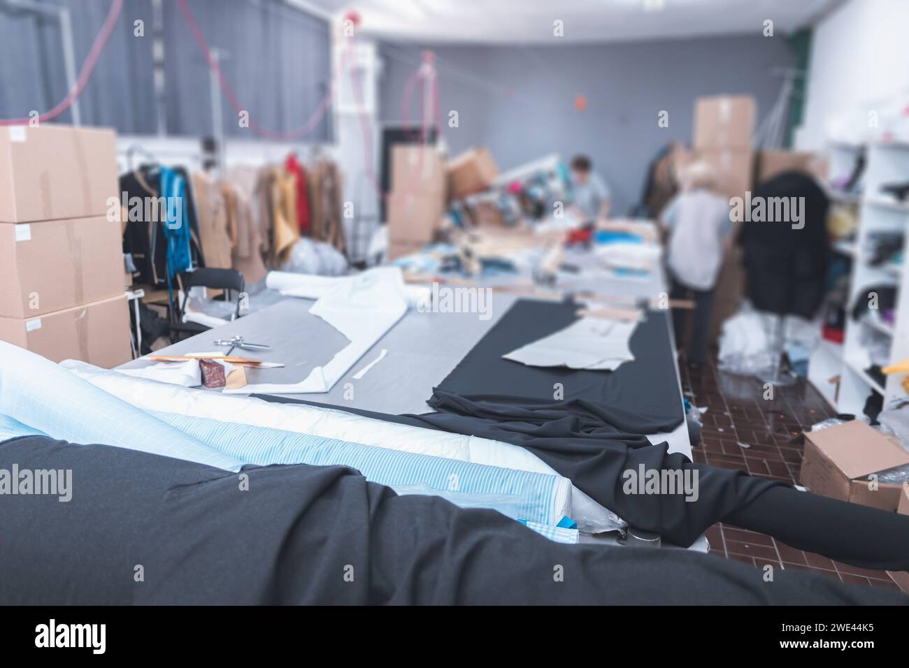 clothing manufacturing facility with fabric on table Stock Photo - Alamy