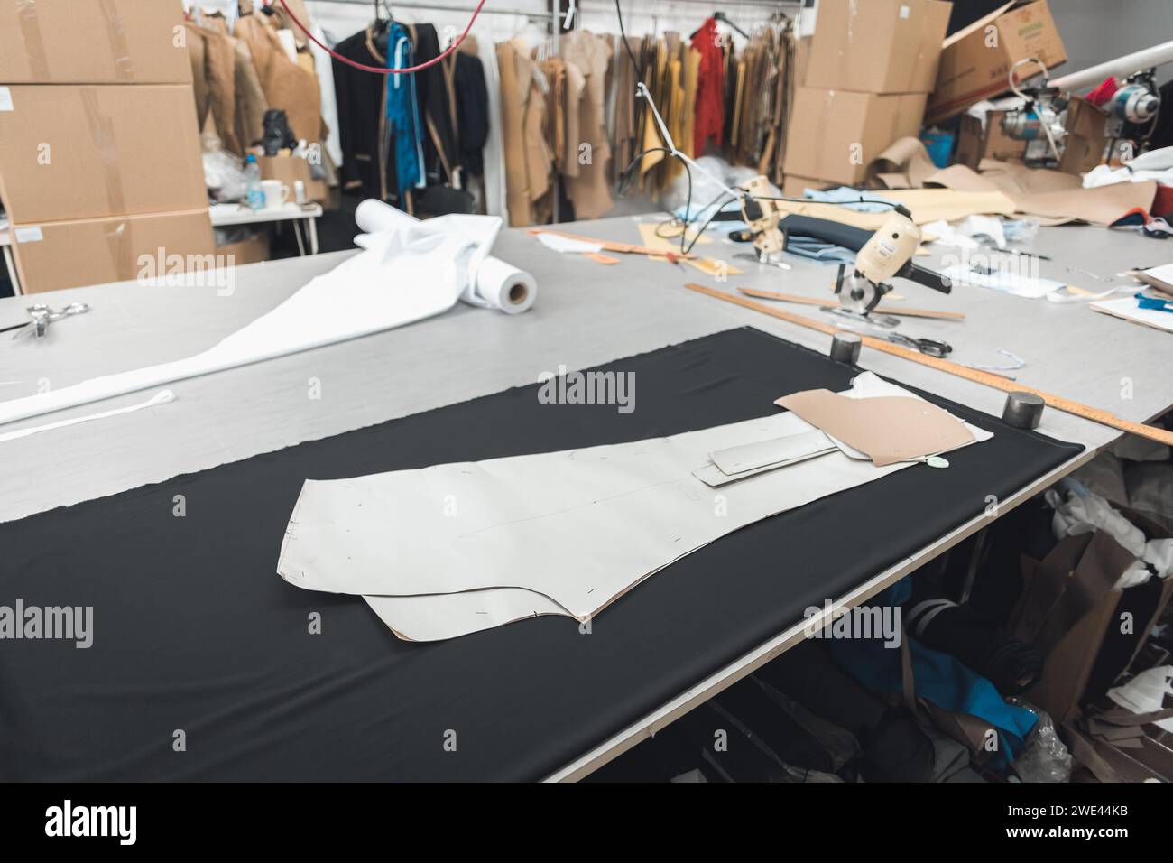clothing manufacturing facility with fabric on table Stock Photo - Alamy