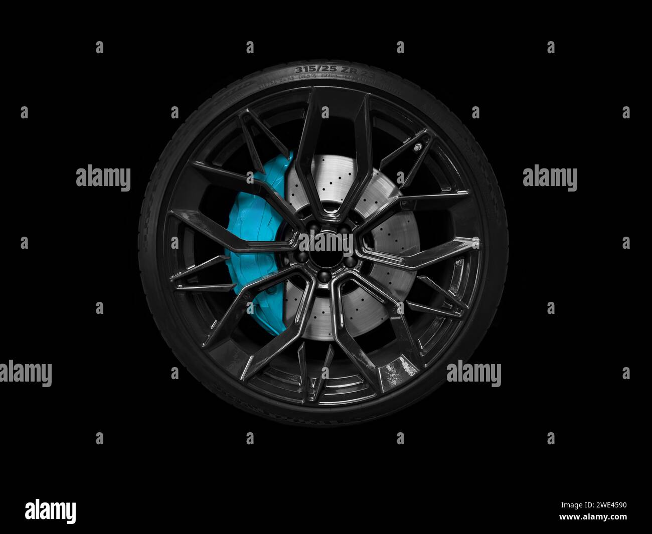 Car alloy wheel and tyre isolated on black background. New alloy wheel ...
