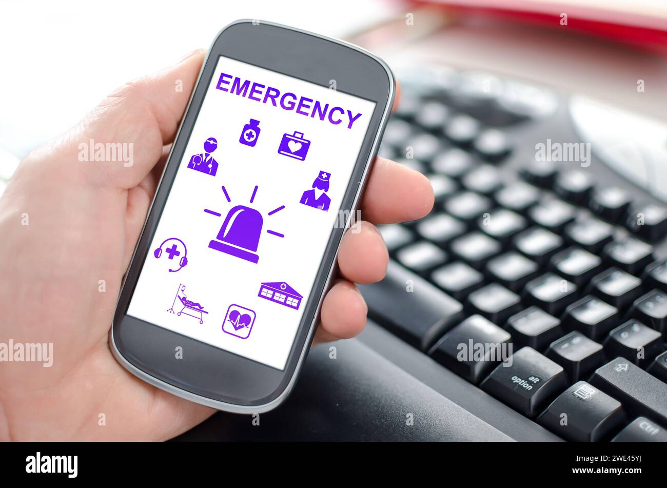 Hand holding a smartphone showing an emergency concept Stock Photo - Alamy