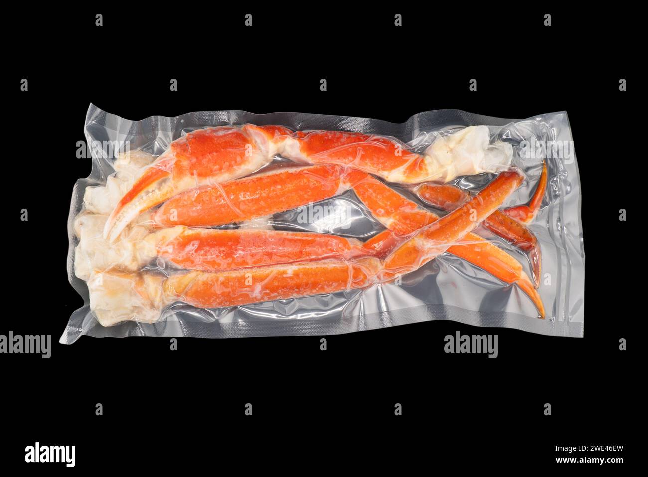 Vacuum packaged Peruvian Southern King crab leg isolated on a black ...