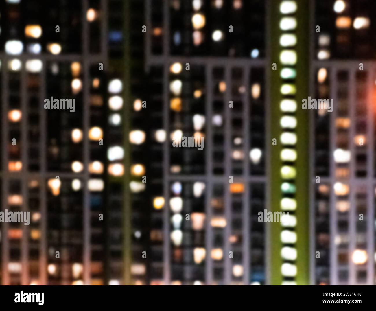 Blurred office building with illuminated facade exterior at night ...