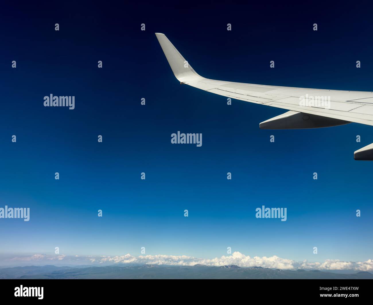 White wing from airplane window on sunny day. Great views of landscape ...