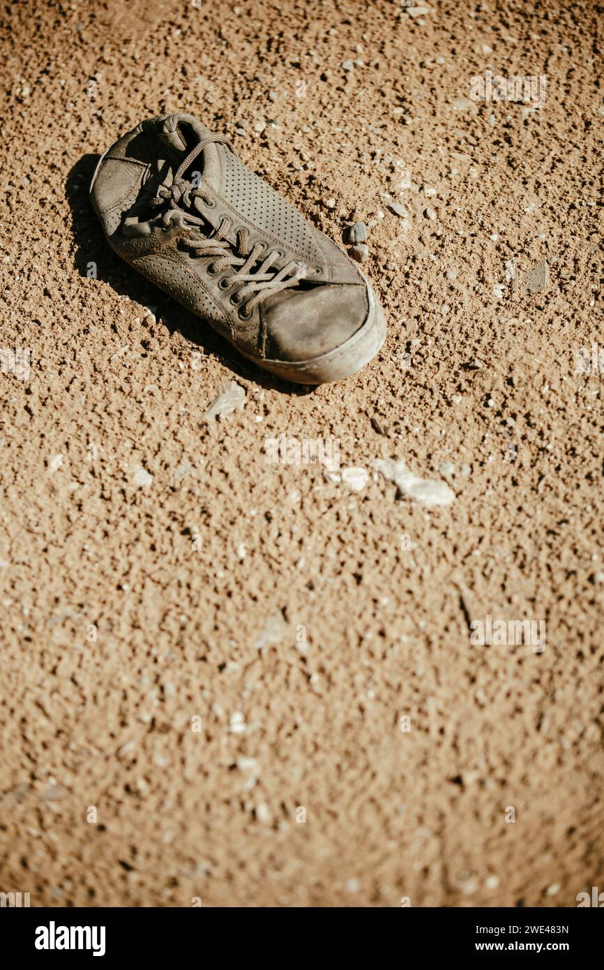 Old dirty shoe on the ground Stock Photo - Alamy