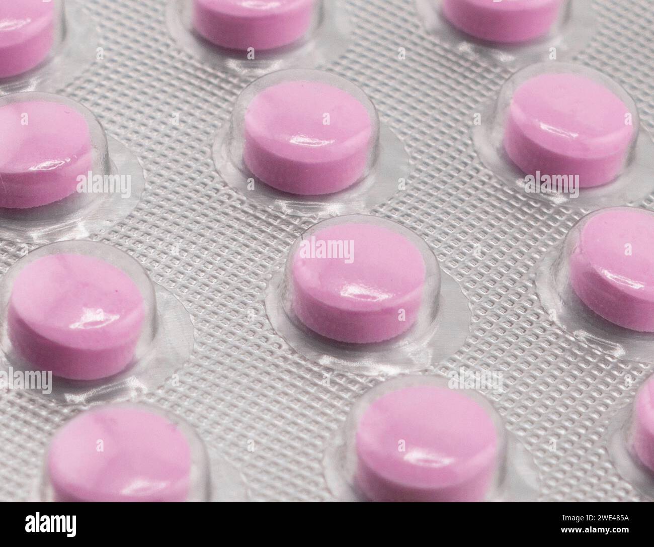 Macro shot pile of tablets pill in silver blister packaging isolated on ...