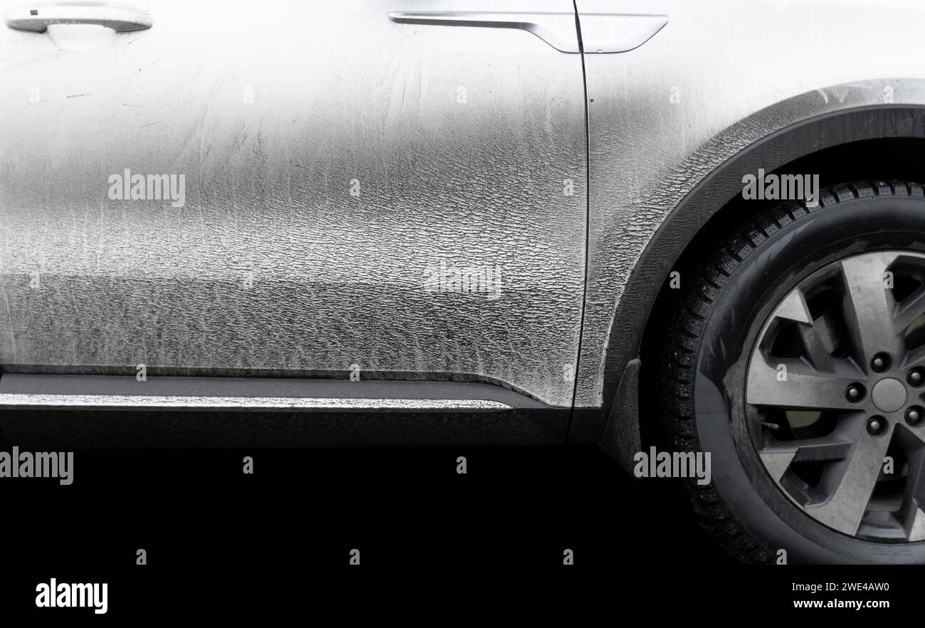 Side view of a very dirty car. Fragment of a dirty car. Dirty ...