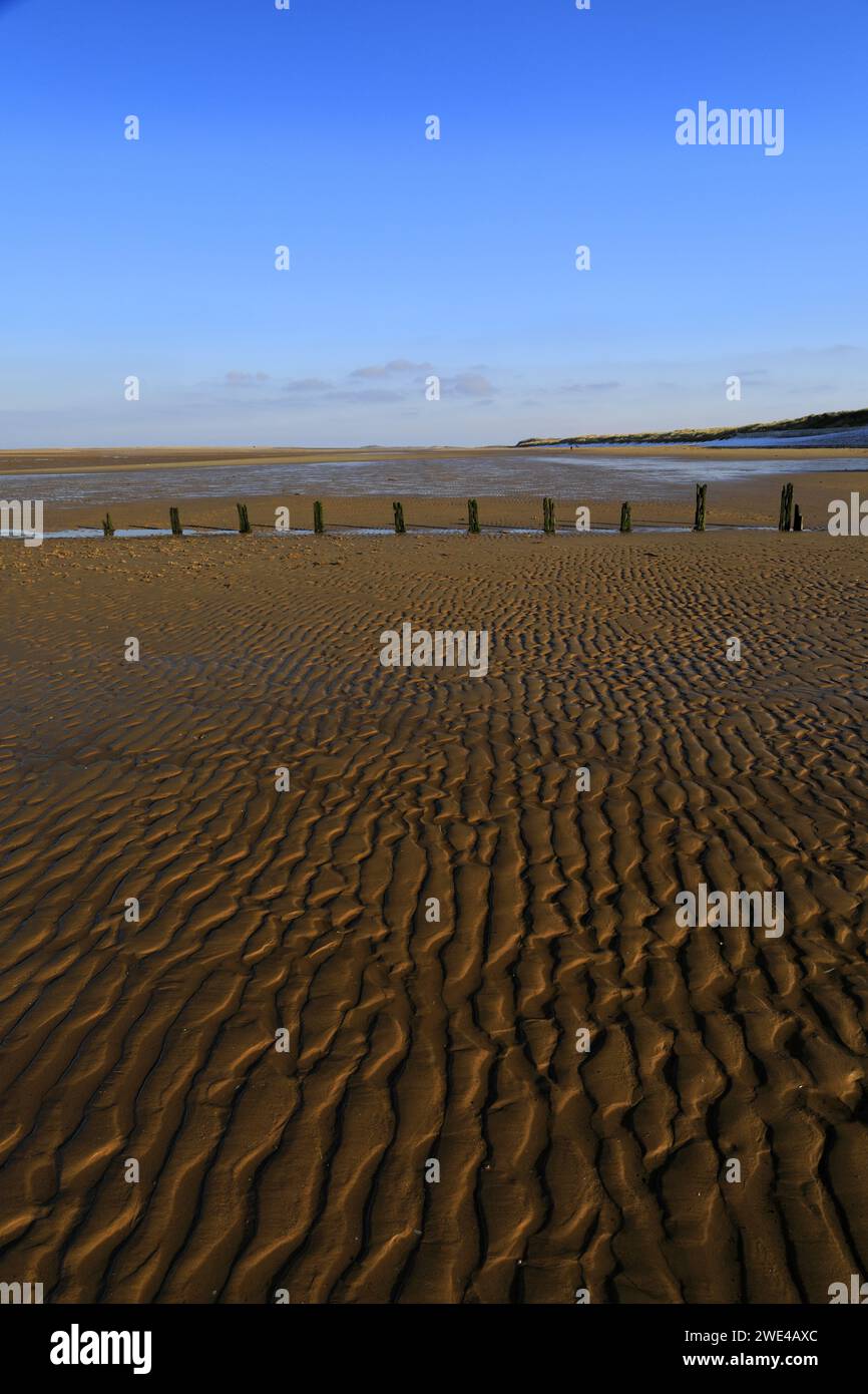 View over the sandy beach at Brancaster, North Norfolk, England, UK ...