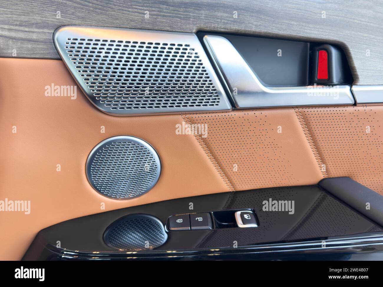 Car door handle inside the luxury modern car with brown leather. Switch ...