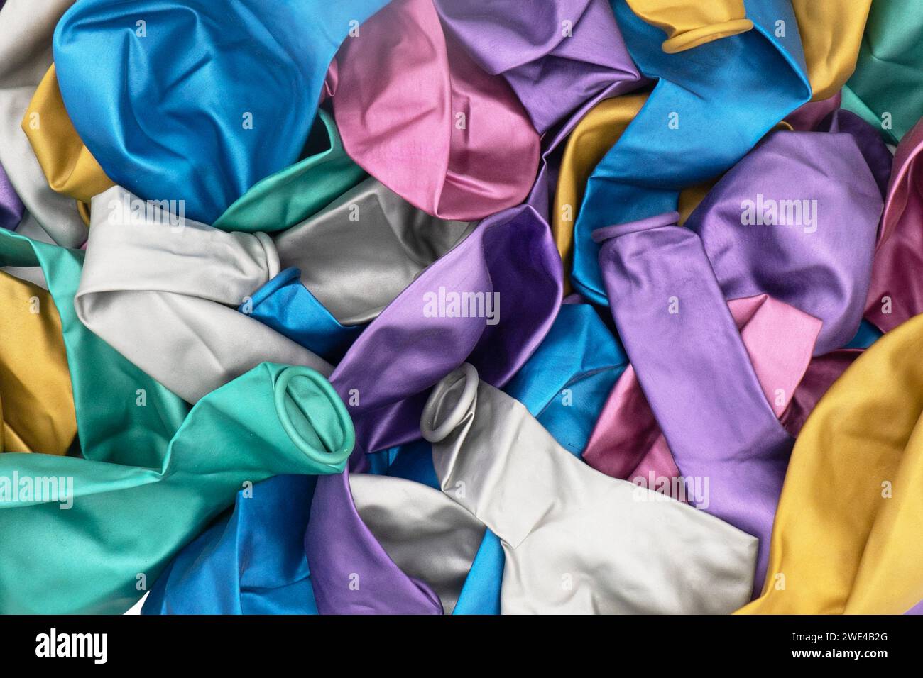 Top view of colorful deflated balloons texture background. Pile of ...