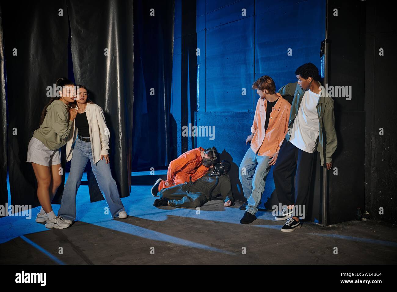 scared multicultural friends looking at freaky people in gas masks and ...