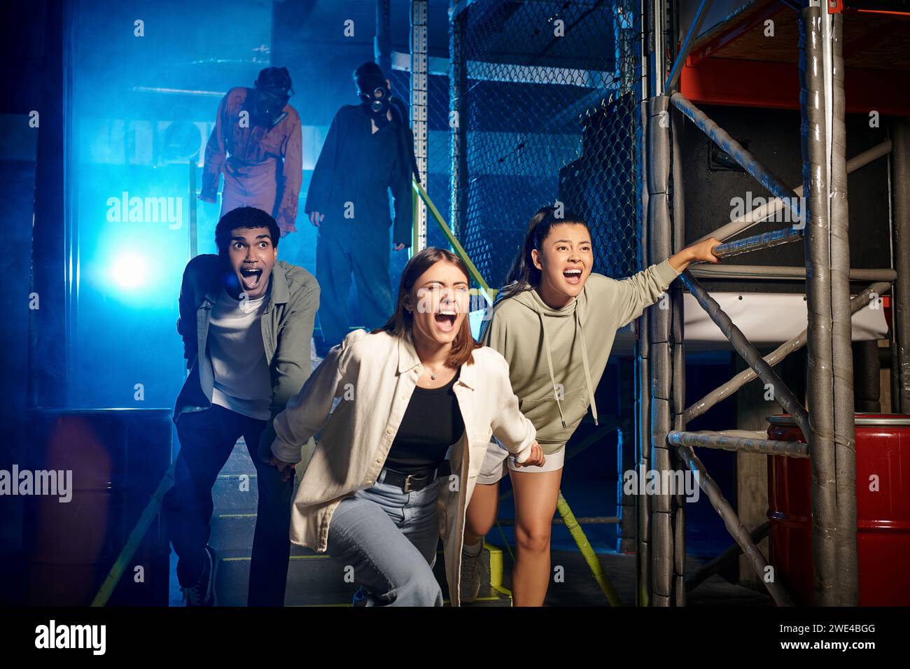 scared multicultural friends running from freaky people in gas masks ...