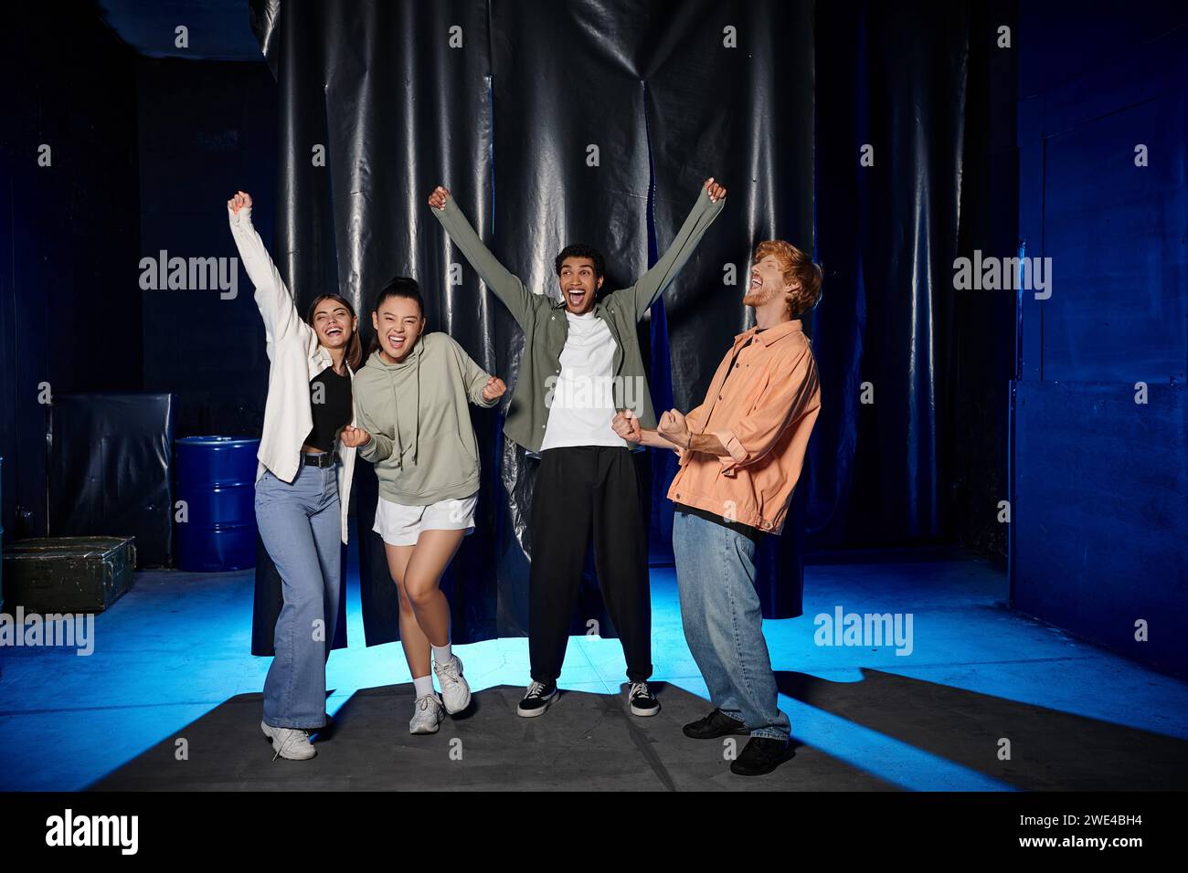group of young multicultural friends celebrating success in an escape ...