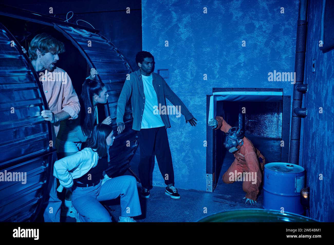 Multicultural group of explores hiding from man in gas mask during ...