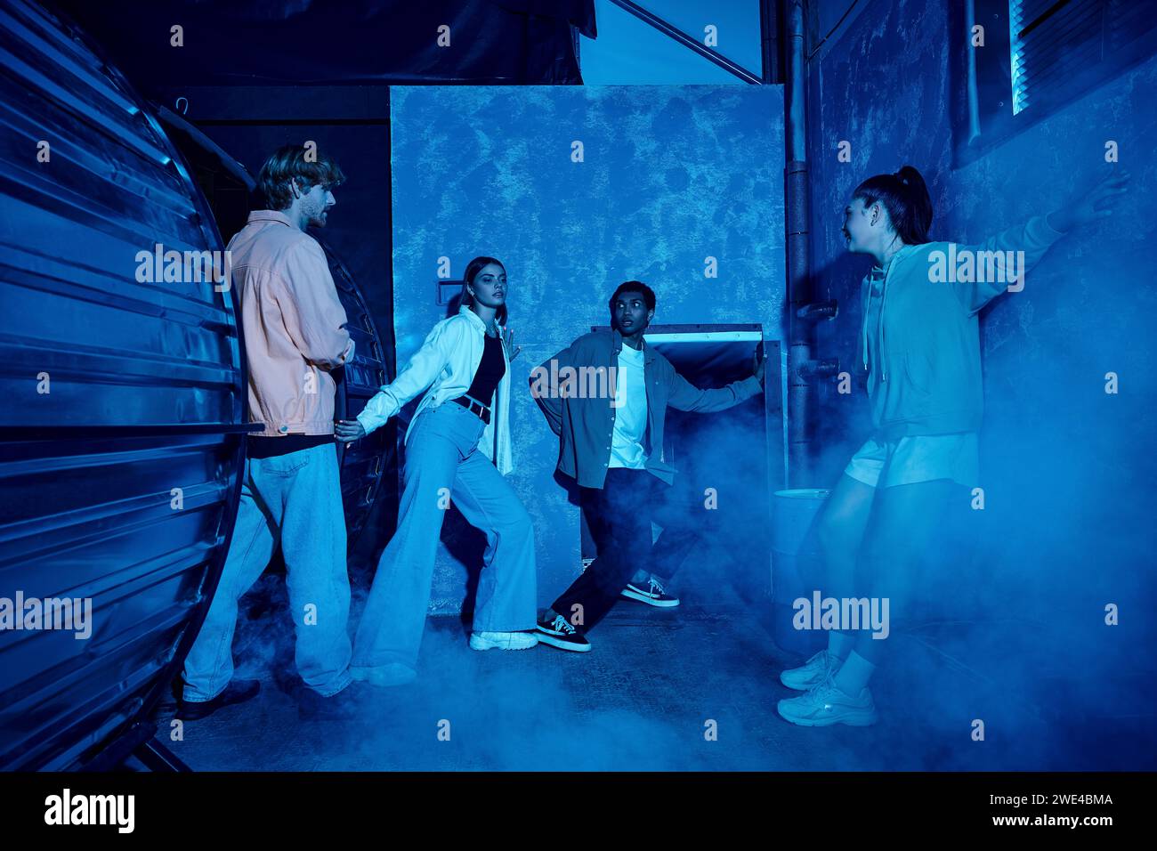 Multicultural group of young friends inside of quest room during escape ...