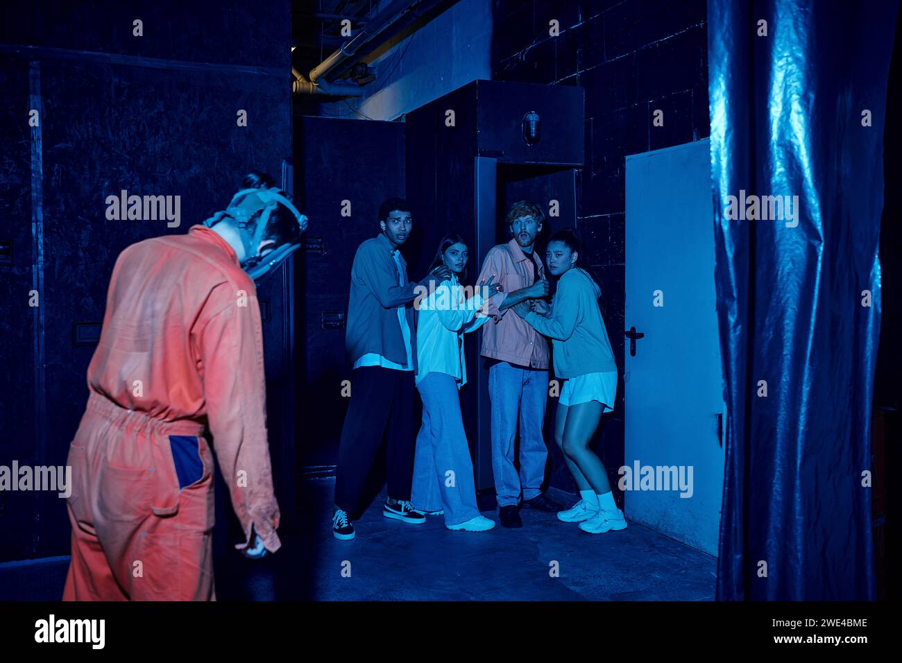 man in gas mast standing near scared multicultural friends in escape ...