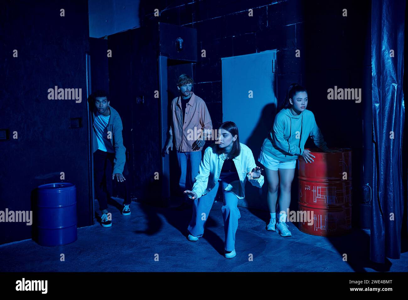 group of multicultural young people engaged in thrilling escape room ...