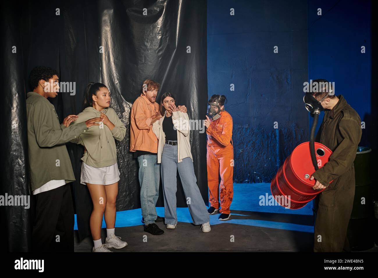 scared interracial friends looking at people in ppe suits and gas masks ...