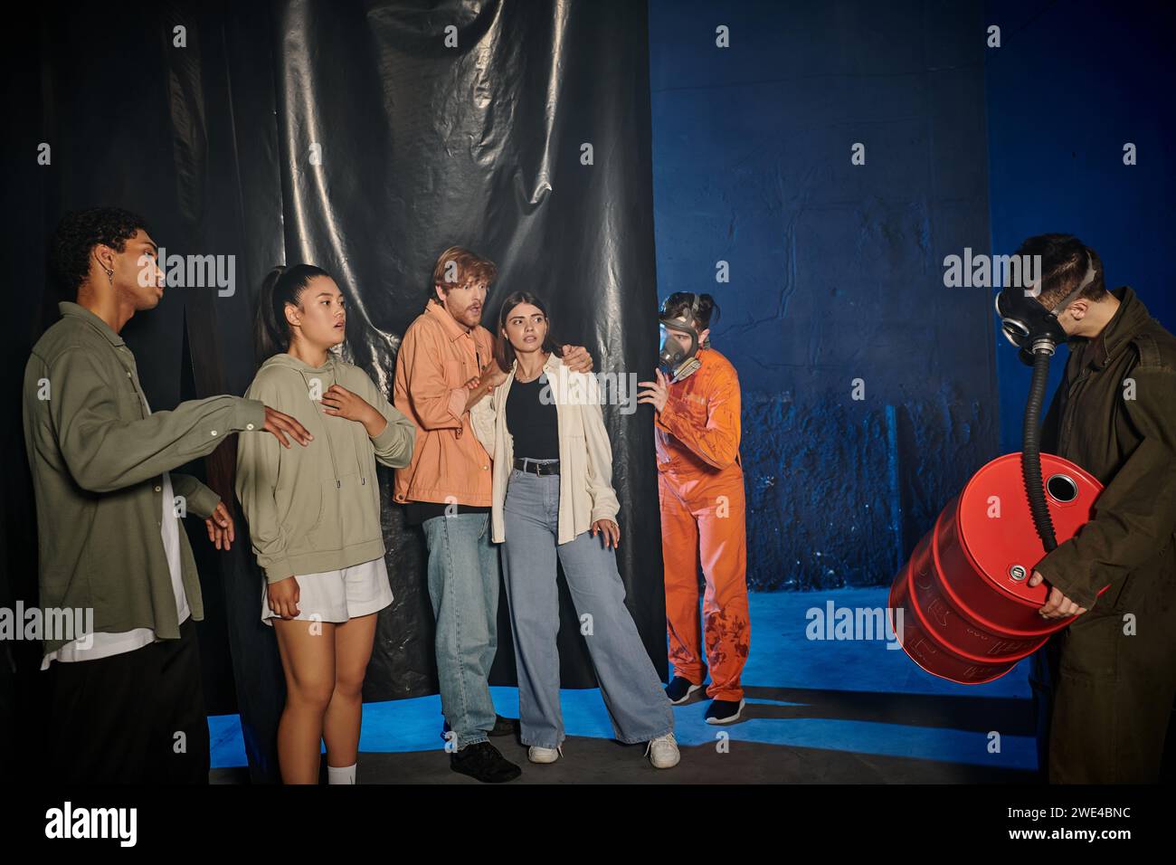 group of scared interracial friends looking at people in ppe suits and ...