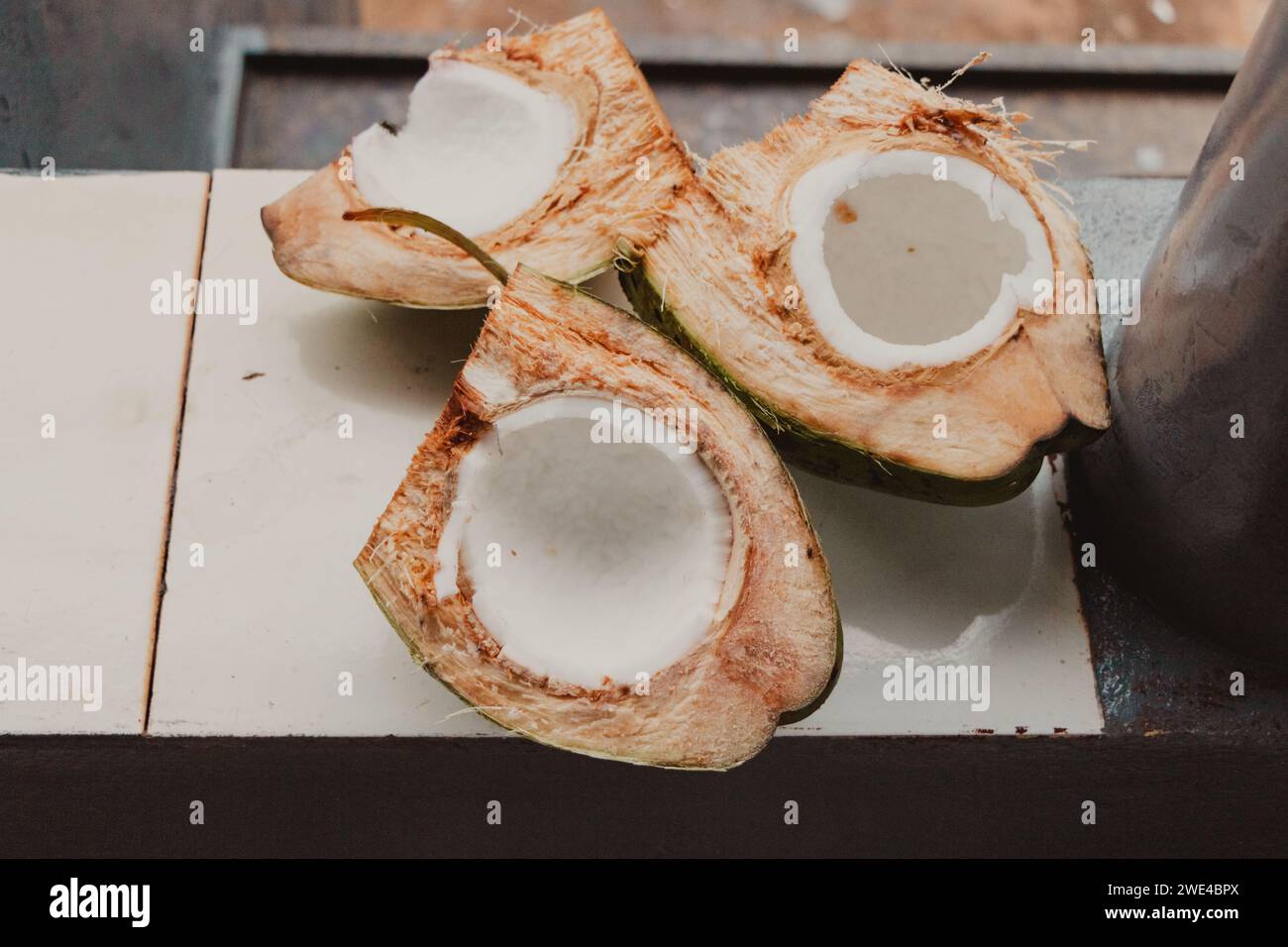 green coconuts cut in half Stock Photo - Alamy